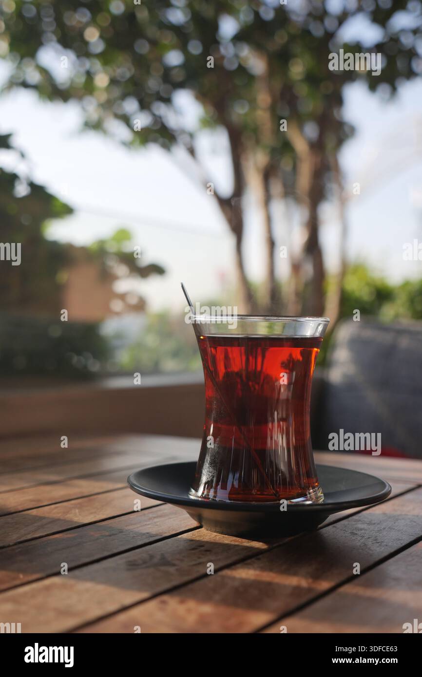Turkish Tea on a wooden table by green plants Stock Photo - Alamy