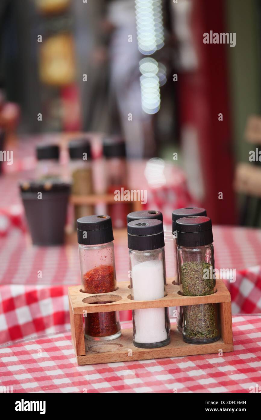Spices and condiments on a table in a restaurant Stock Photo - Alamy