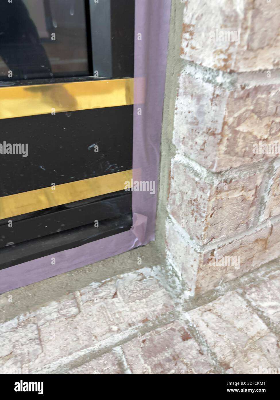 Close-up of the bottom corner of a fireplace insert where purple ...