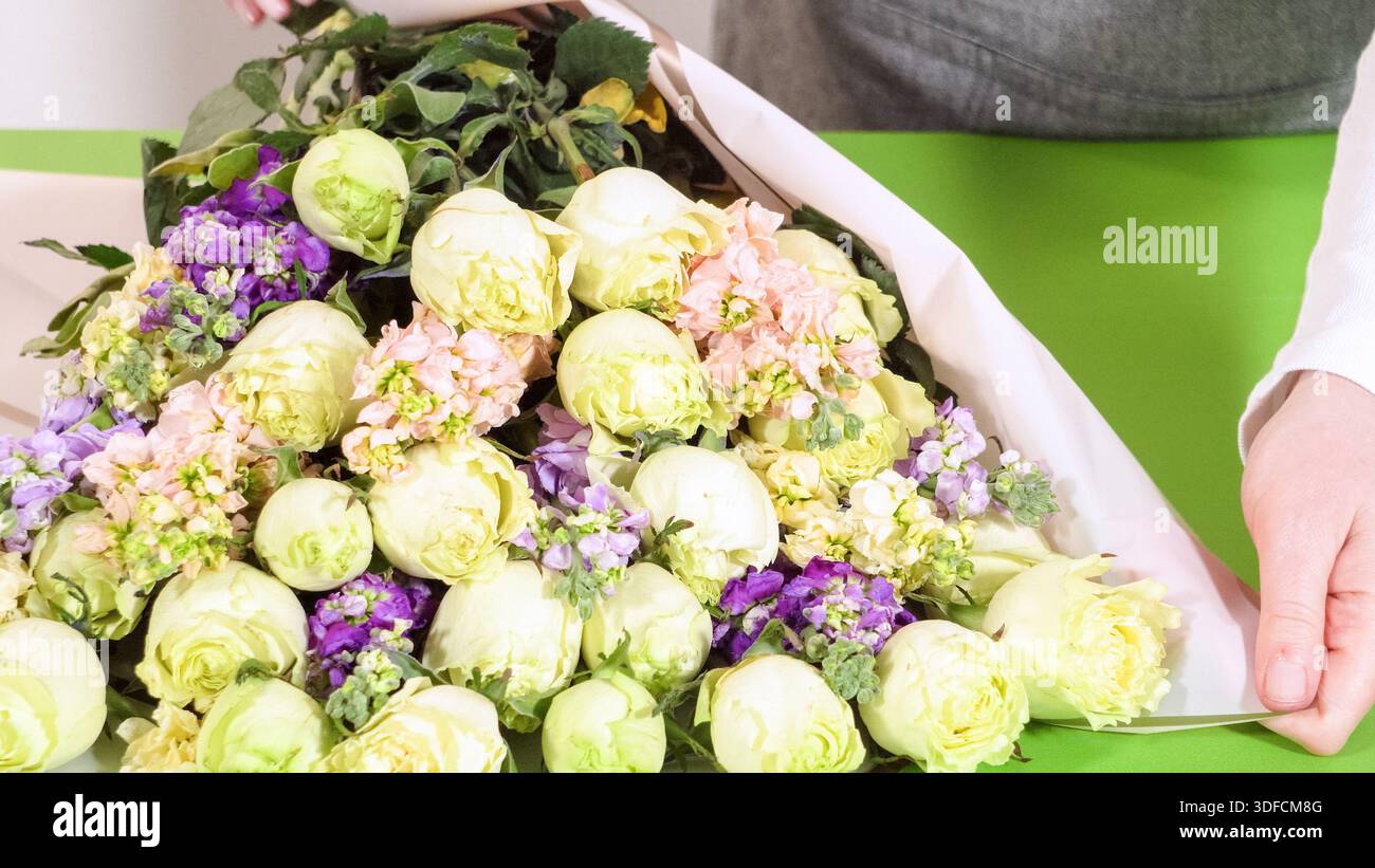 Aligning floral bouquet on wrapping paper Stock Photo - Alamy