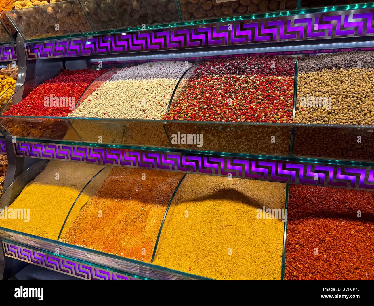Colorful ground spices arranged in glass bins with geometric lighting ...