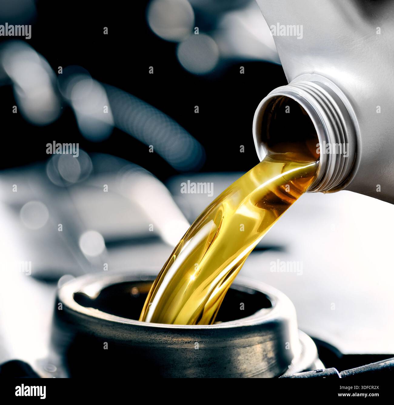 Pouring motor oil from silver plastic canister. Regular and routine ...