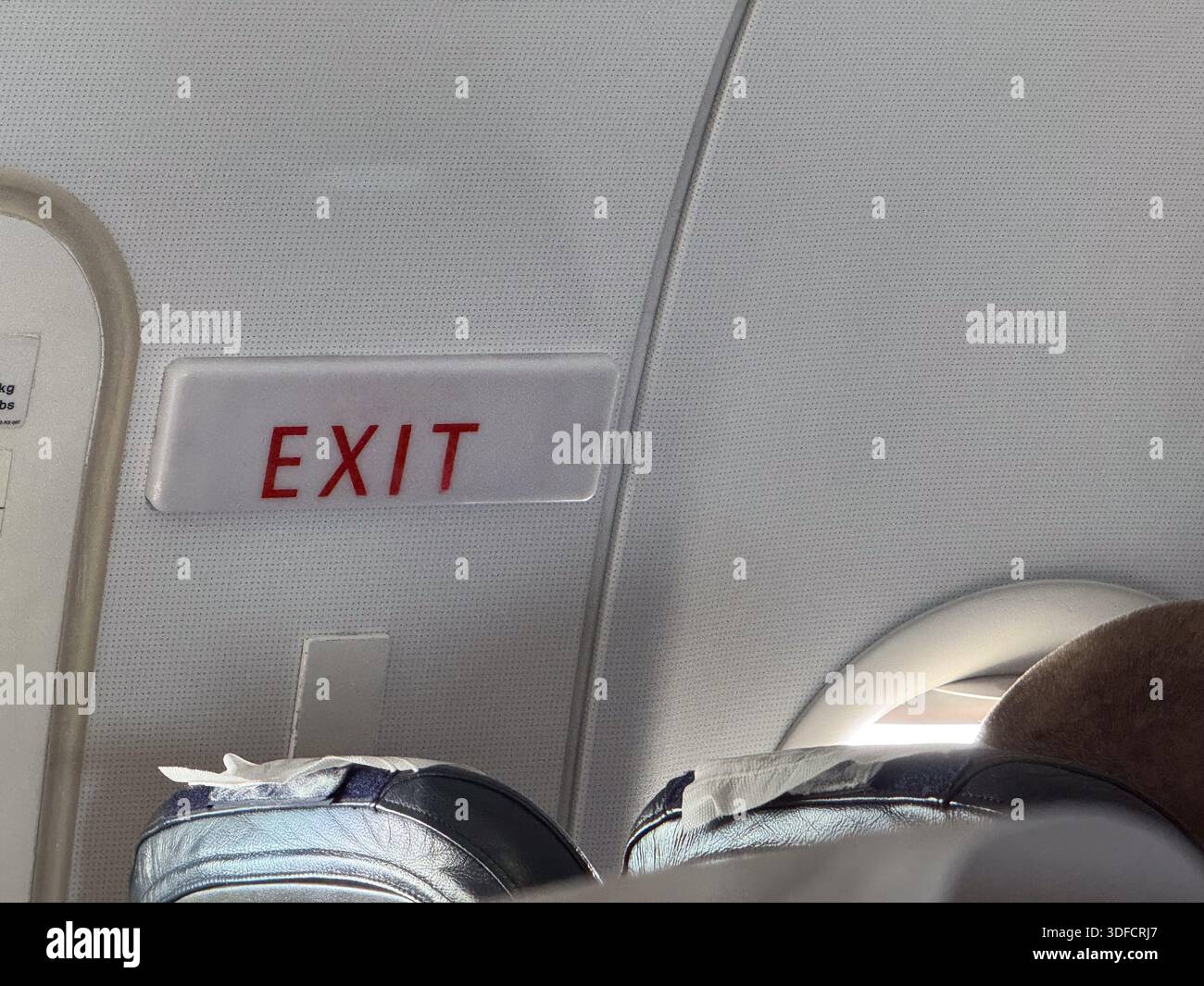 Airplane exit sign with bilingual marking. Safety, navigation, and ...