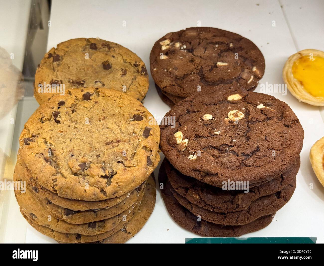 Chocolate chip and cocoa cookies stacked in bakery case. Homemade style ...