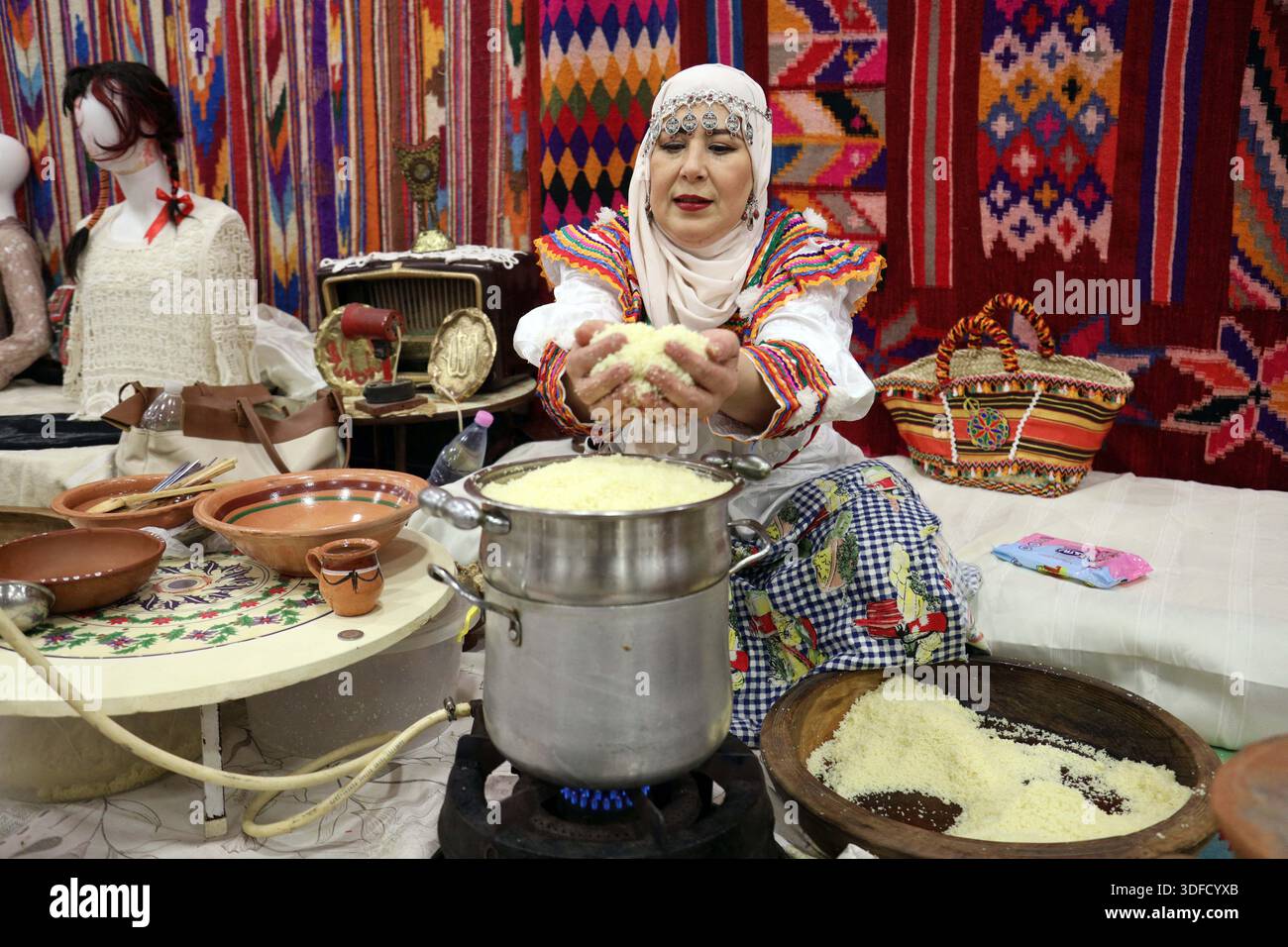 An Algerian woman wears a Kabyle dress and prepares couscous during the ...