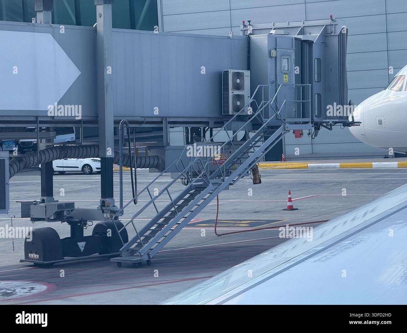 Passenger boarding bridge with stairs at airport gate. Ground ...