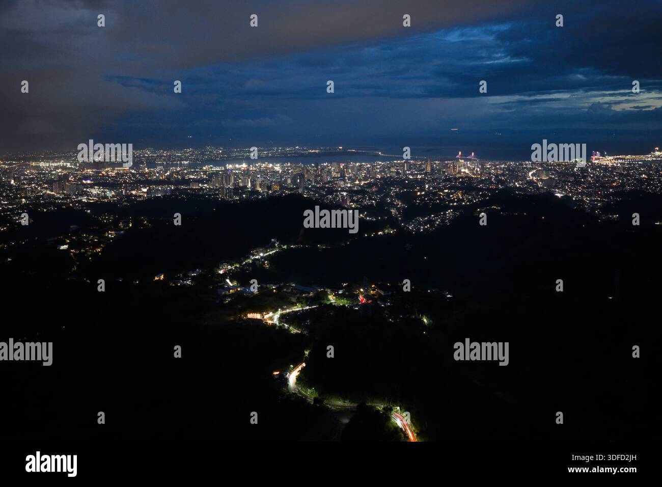 Aerial view of the city lights twinkling like stars against the dark ...