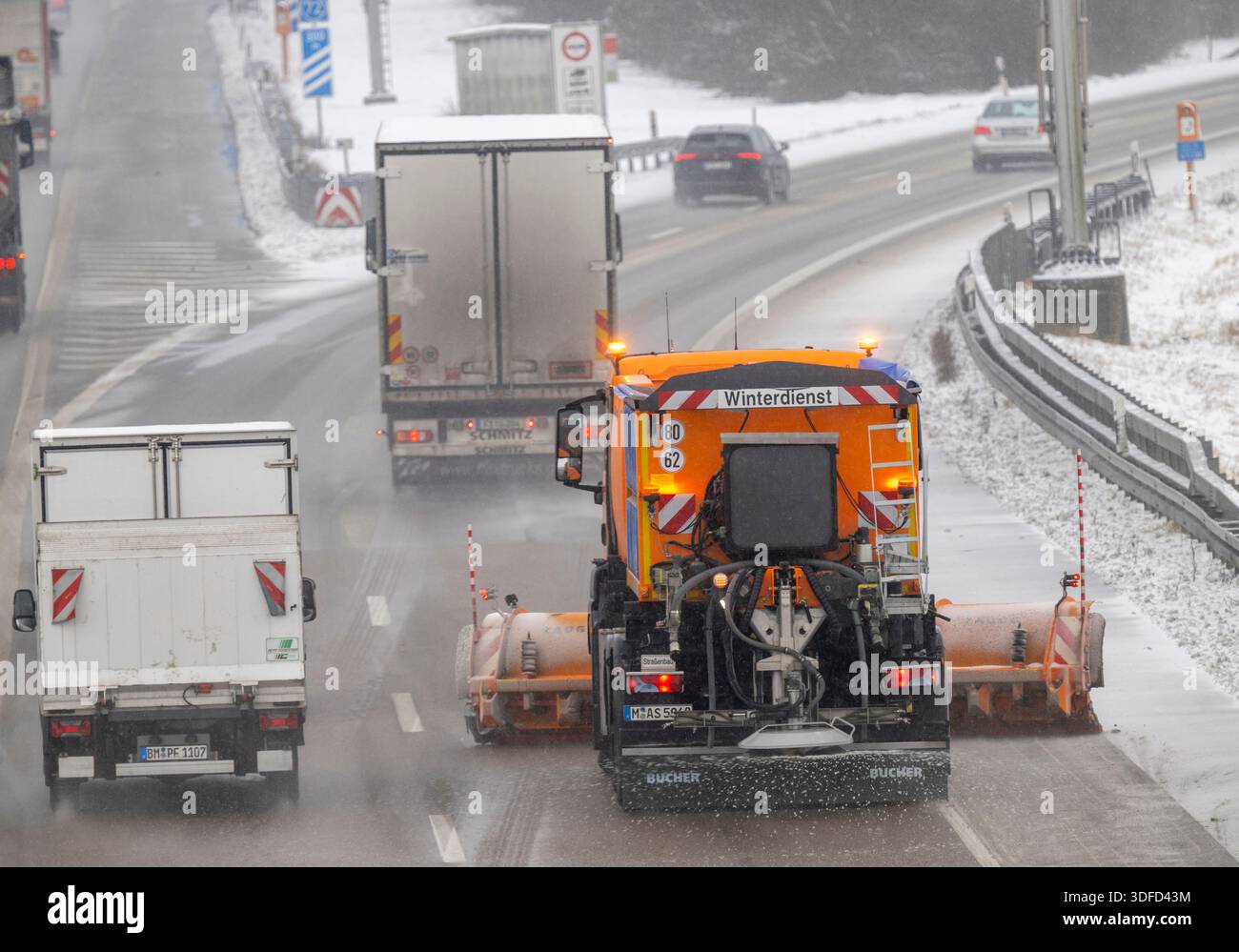 12 January 2026, Bavaria, Munich: A snow runner, cars and trucks drive ...