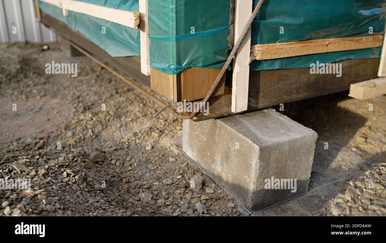 Construction site showing work in progress. Concrete block supporting a ...