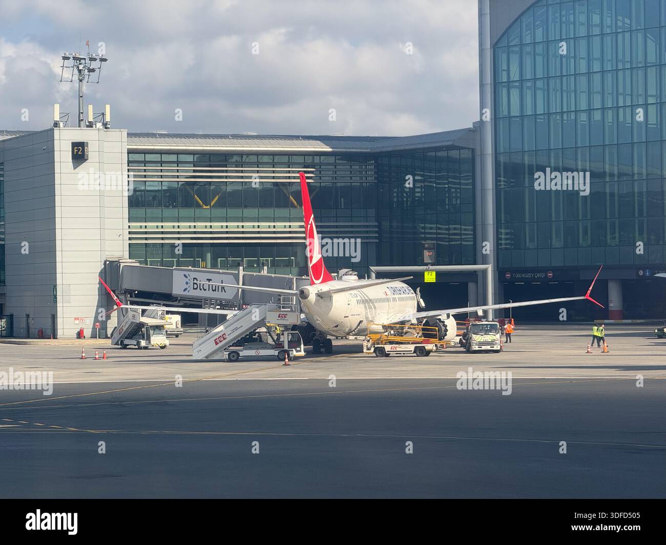 Passenger airplane serviced at airport gate. Ground handling, aircraft ...