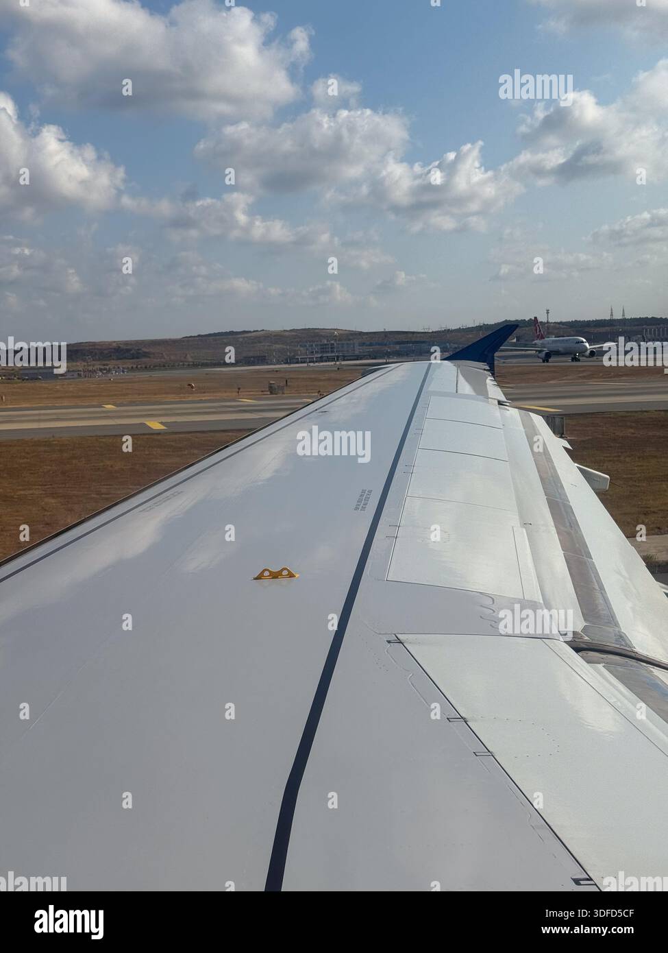 Airplane wing seen from passenger window on runway. Preflight movement ...