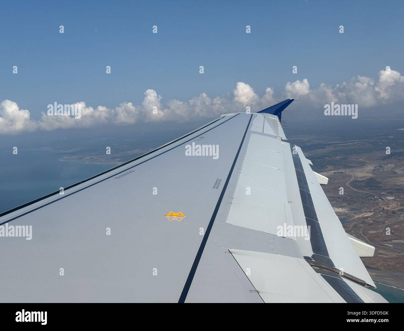 Aircraft wing flying above coast and land. Aerial travel, flight ...