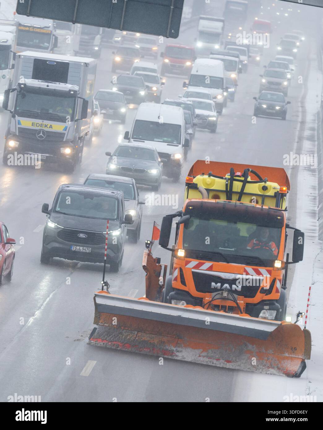 12 January 2026, Bavaria, Munich: A snow runner, cars and trucks drive ...