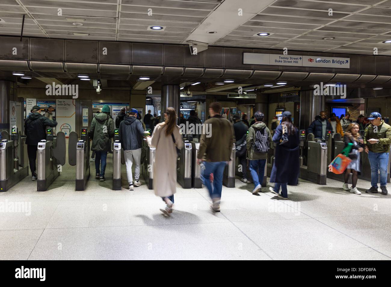 Busy London Underground station interior with commuters, showing public ...