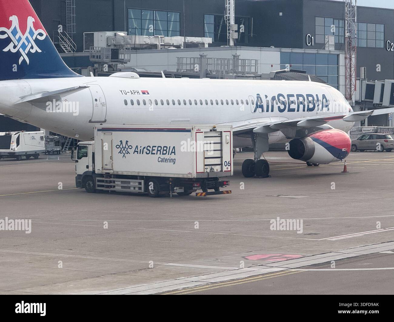 Air Serbia airplane beside catering truck at airport gate. Ground ...