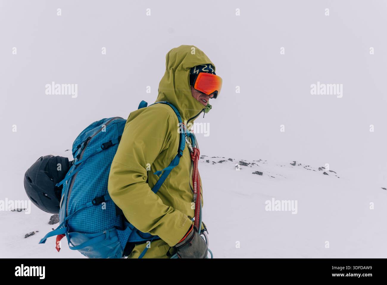 A skier gathers a rope in a whiteout storm in the Northern Rockies in ...