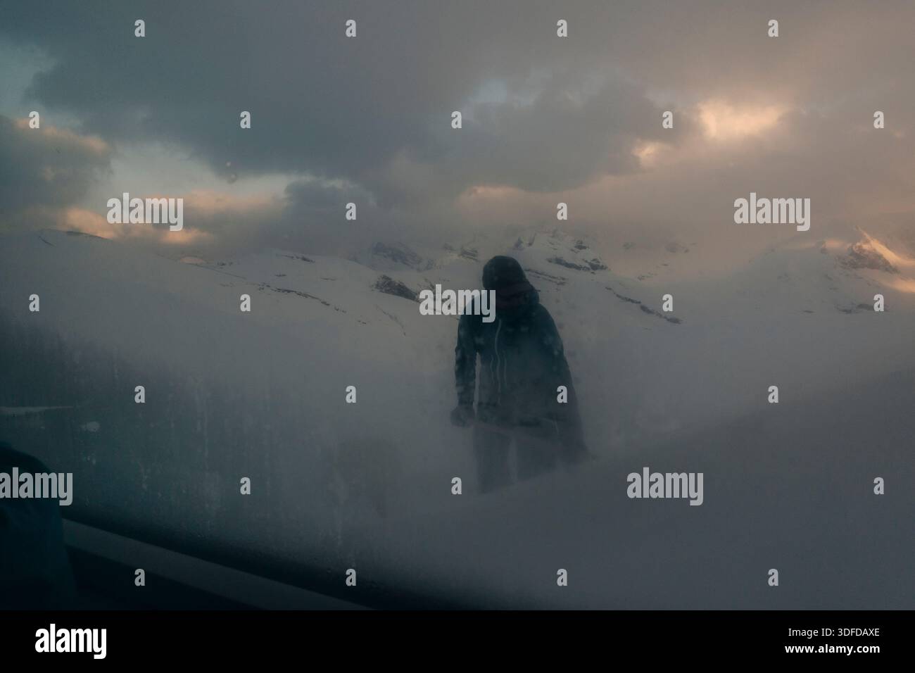 A man digs snow for drinking water outside a backcountry hut in the ...
