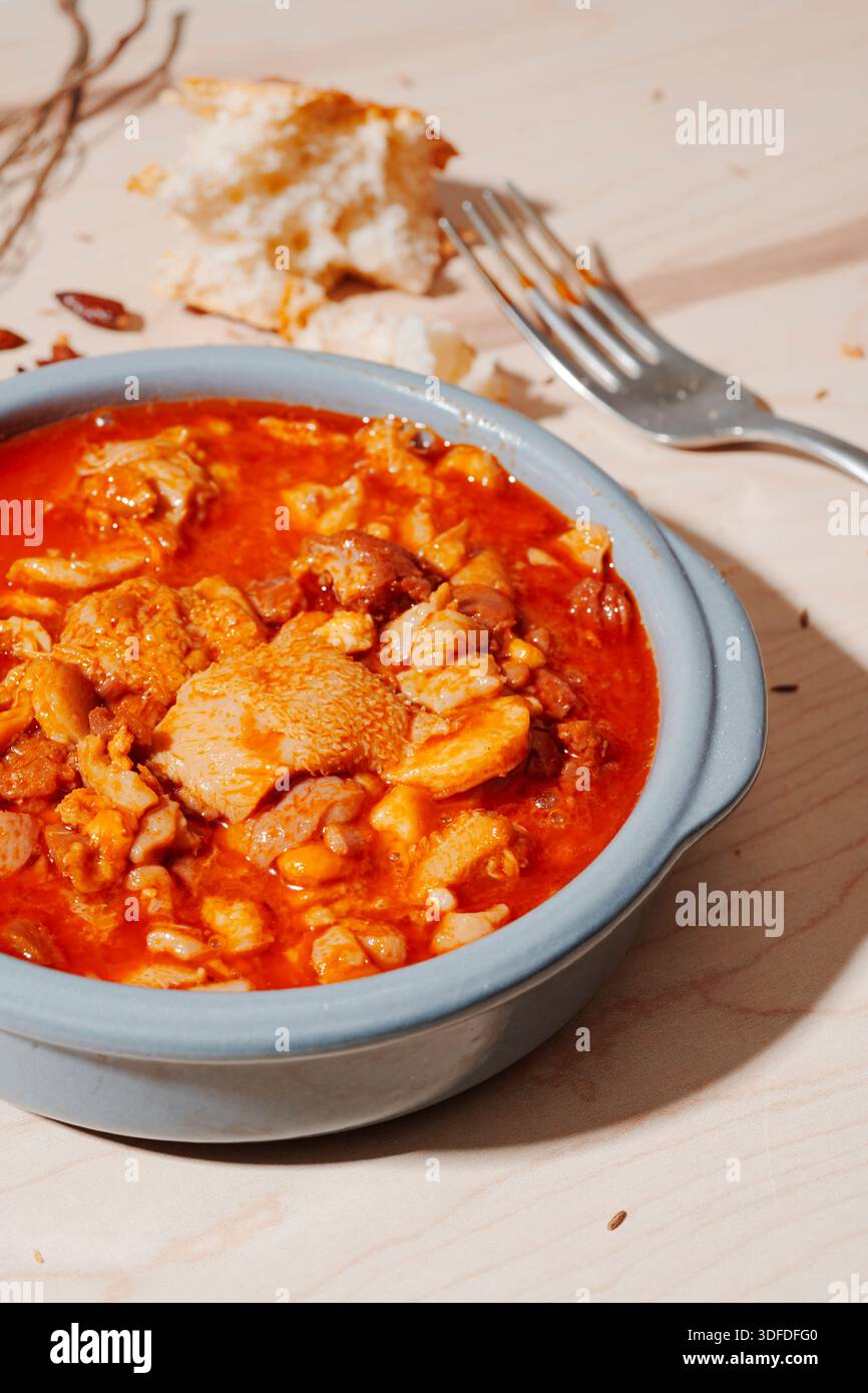 a serving of Spanish callos made from beef tripe stewed in a bold red ...