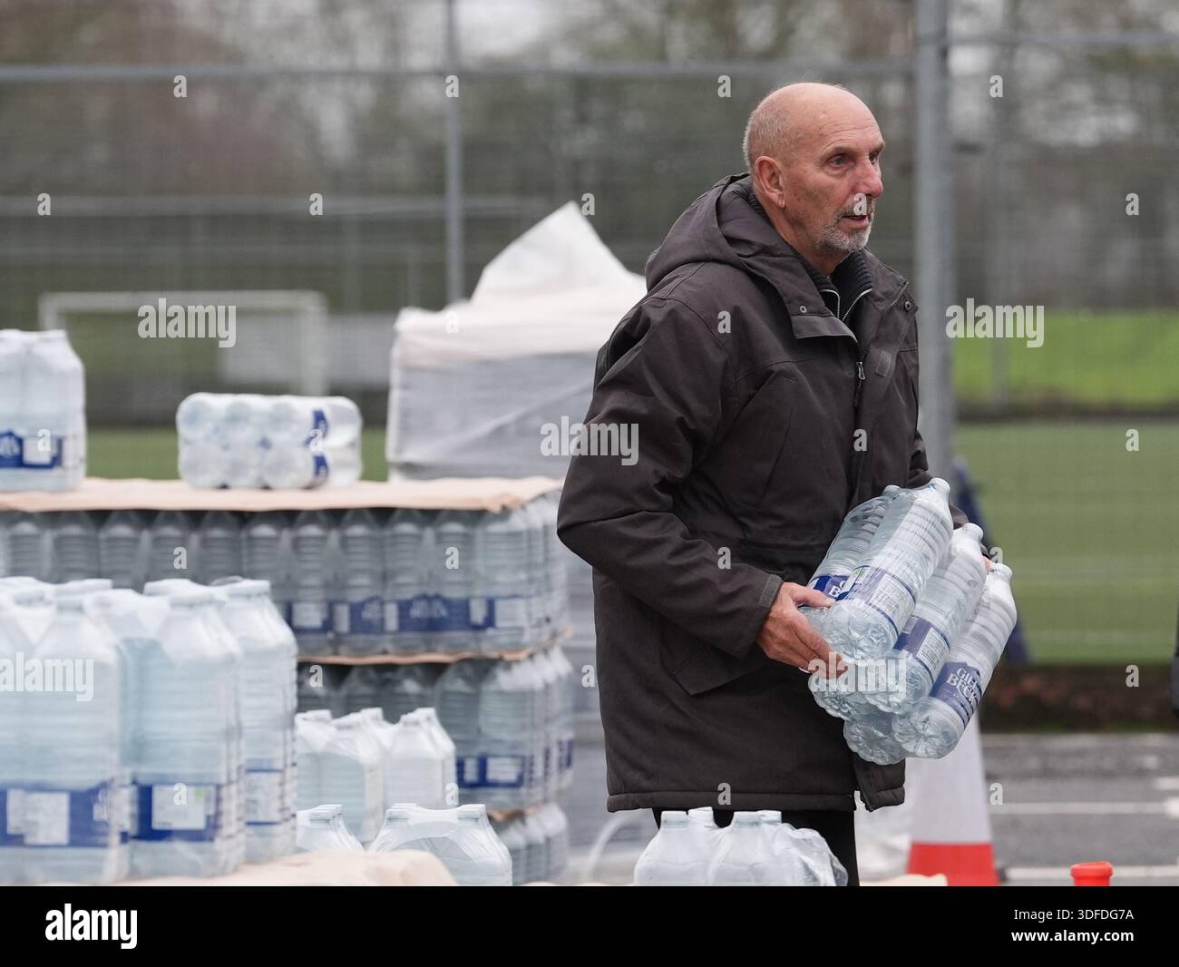 A man collects bottled water from a water station in East Grinstead ...
