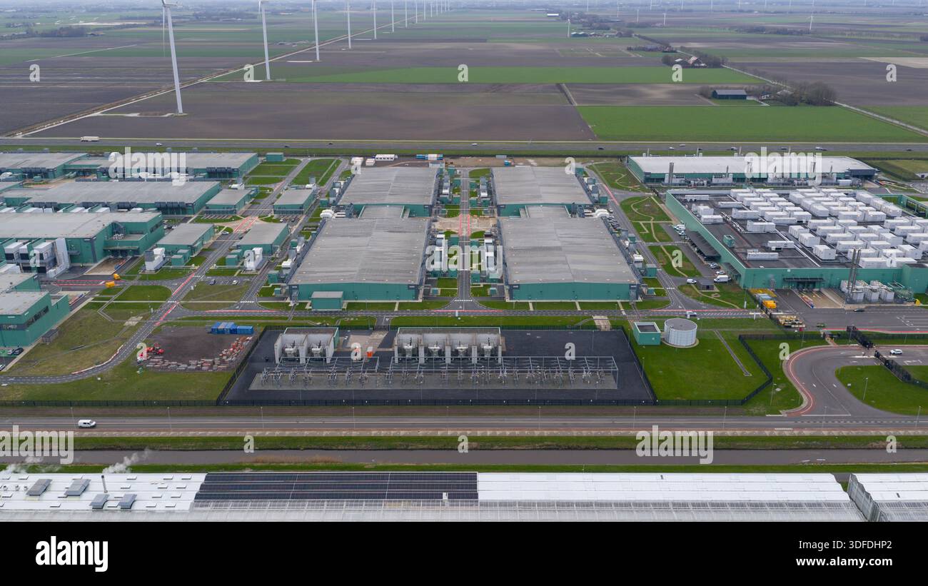 Aerial view of sprawling data centers contrasting against the vast ...