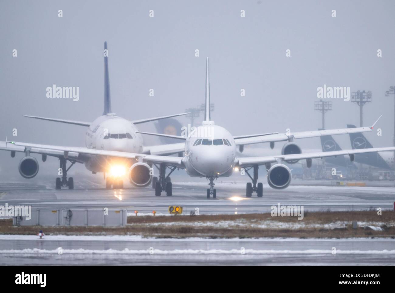 12 January 2026, Hesse, Frankfurt/Main: Passenger planes wait for ...