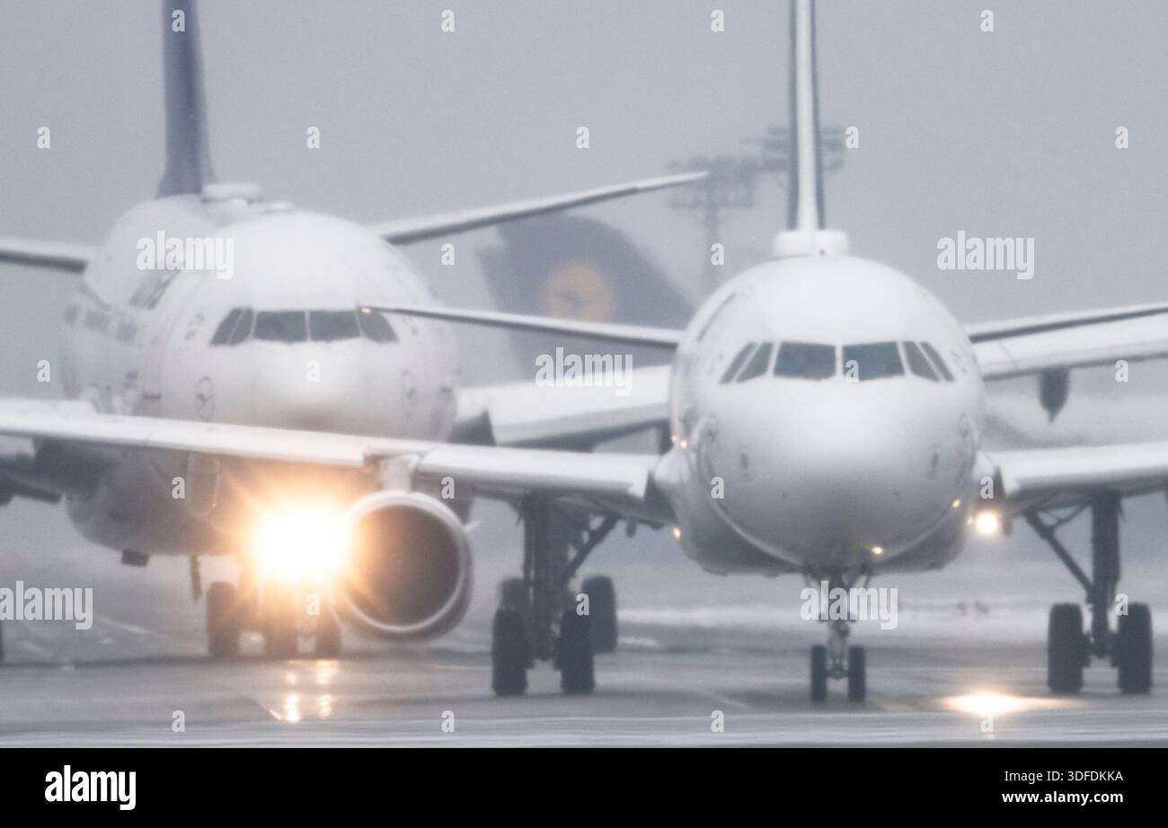 12 January 2026, Hesse, Frankfurt/Main: Passenger planes wait for ...