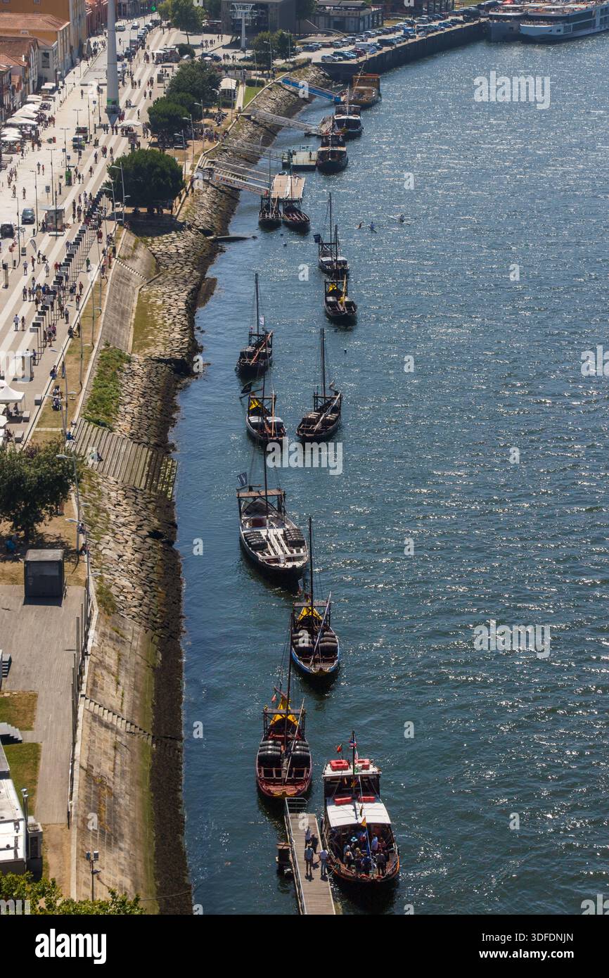 The Typical ships at the shore of Douro river, port wine wineries and ...