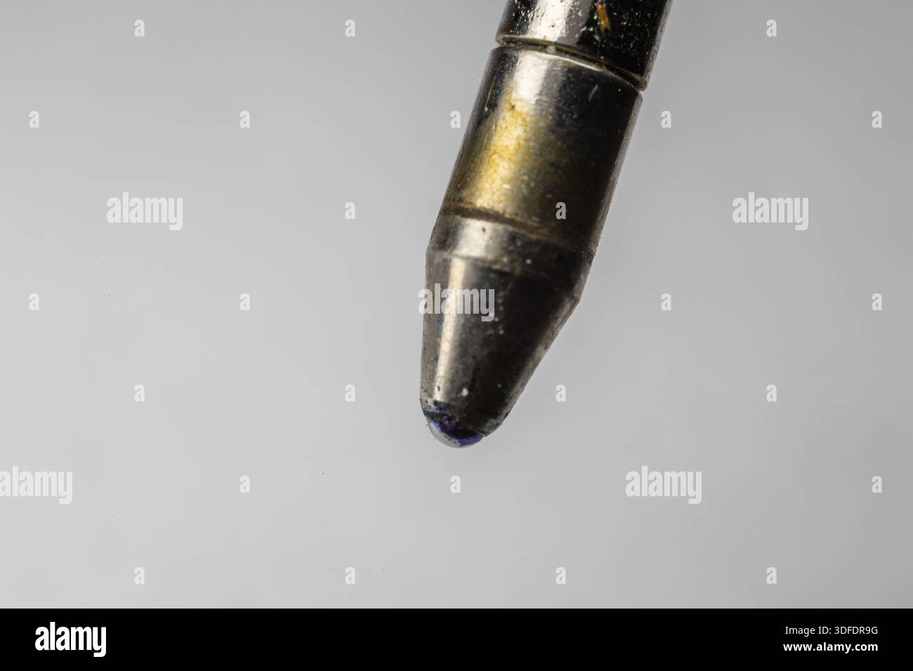 Ballpoint pen refill with ink ball writes on paper very close up Stock ...