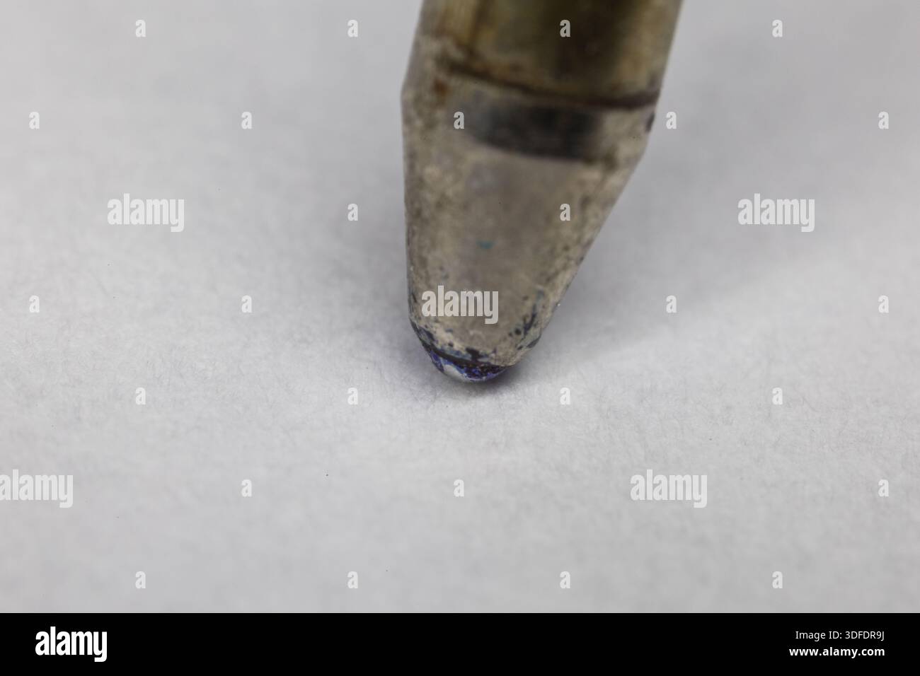 Ballpoint pen refill with ink ball writes on paper very close up Stock ...