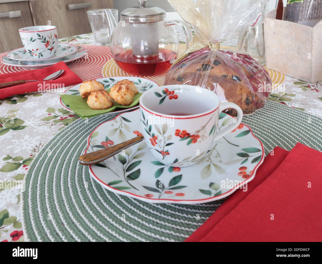 Table setting with bright tableware, berries, and twigs. Italian ...
