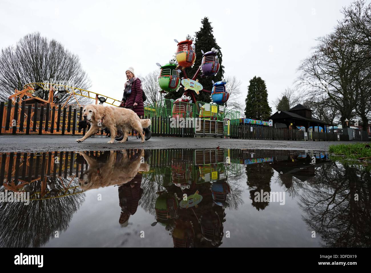 People walk their dogs by a puddle at St Nicholas' Park in Warwick ...