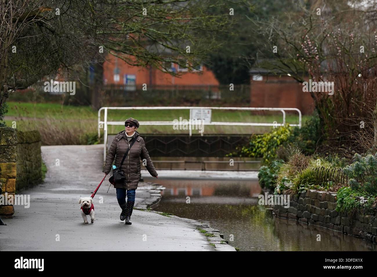 A person walks their dog in St Nicholas' Park in Warwick. Heavy rain ...