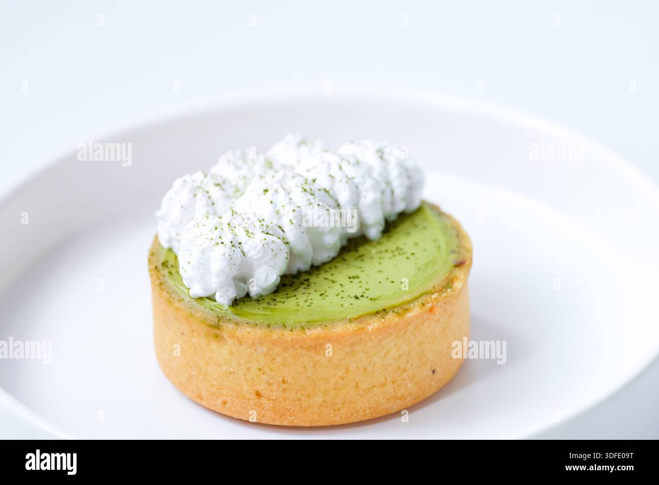 Matcha cheese tart on a white plate Stock Photo - Alamy