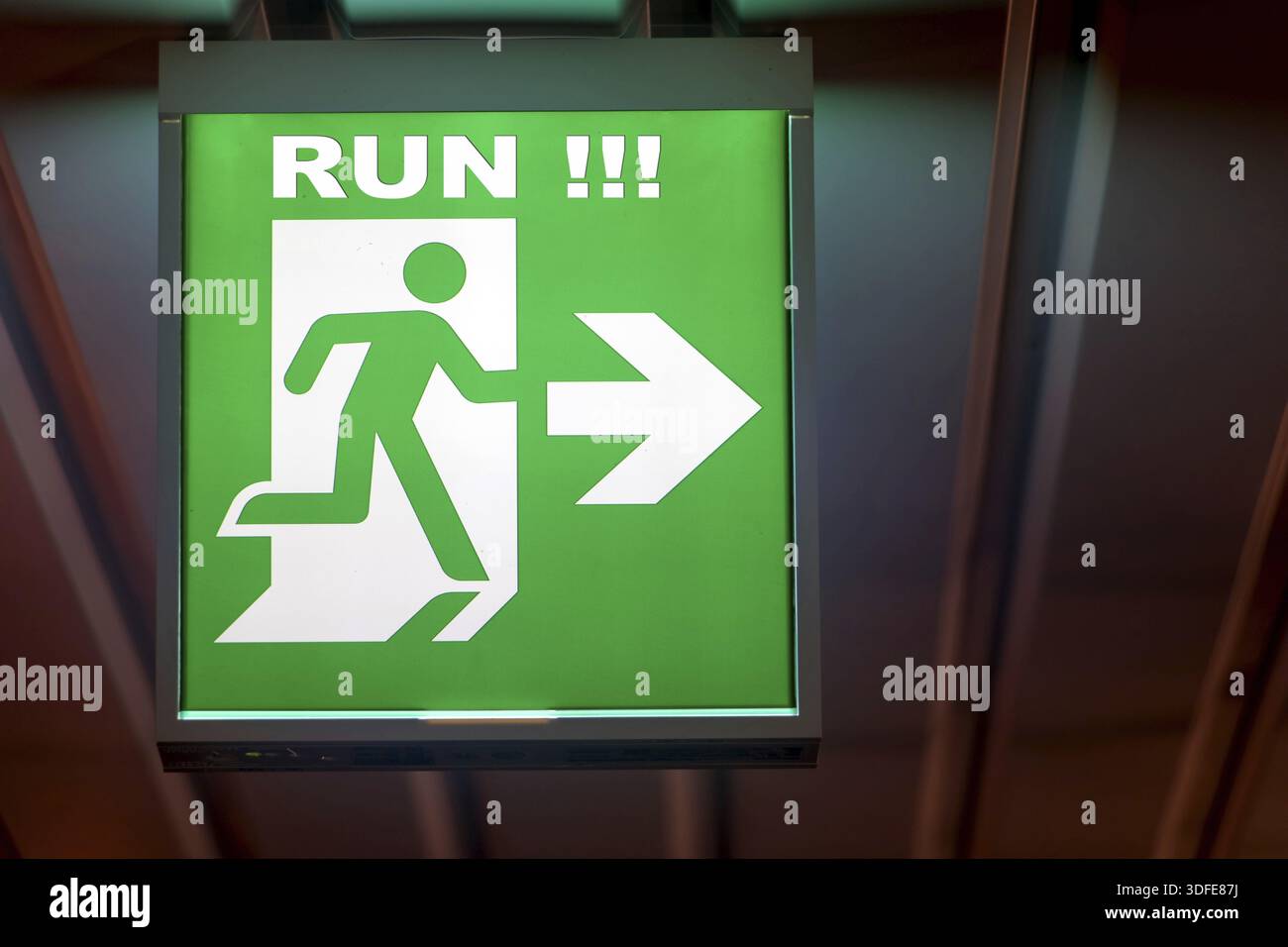 The emergency exit sign RUN! shows the direction of escape in case of ...