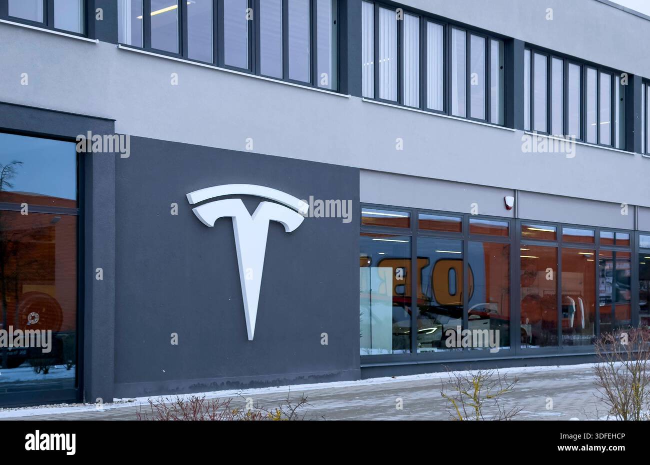 Exterior view of a Tesla industrial facility with a long gray facade ...