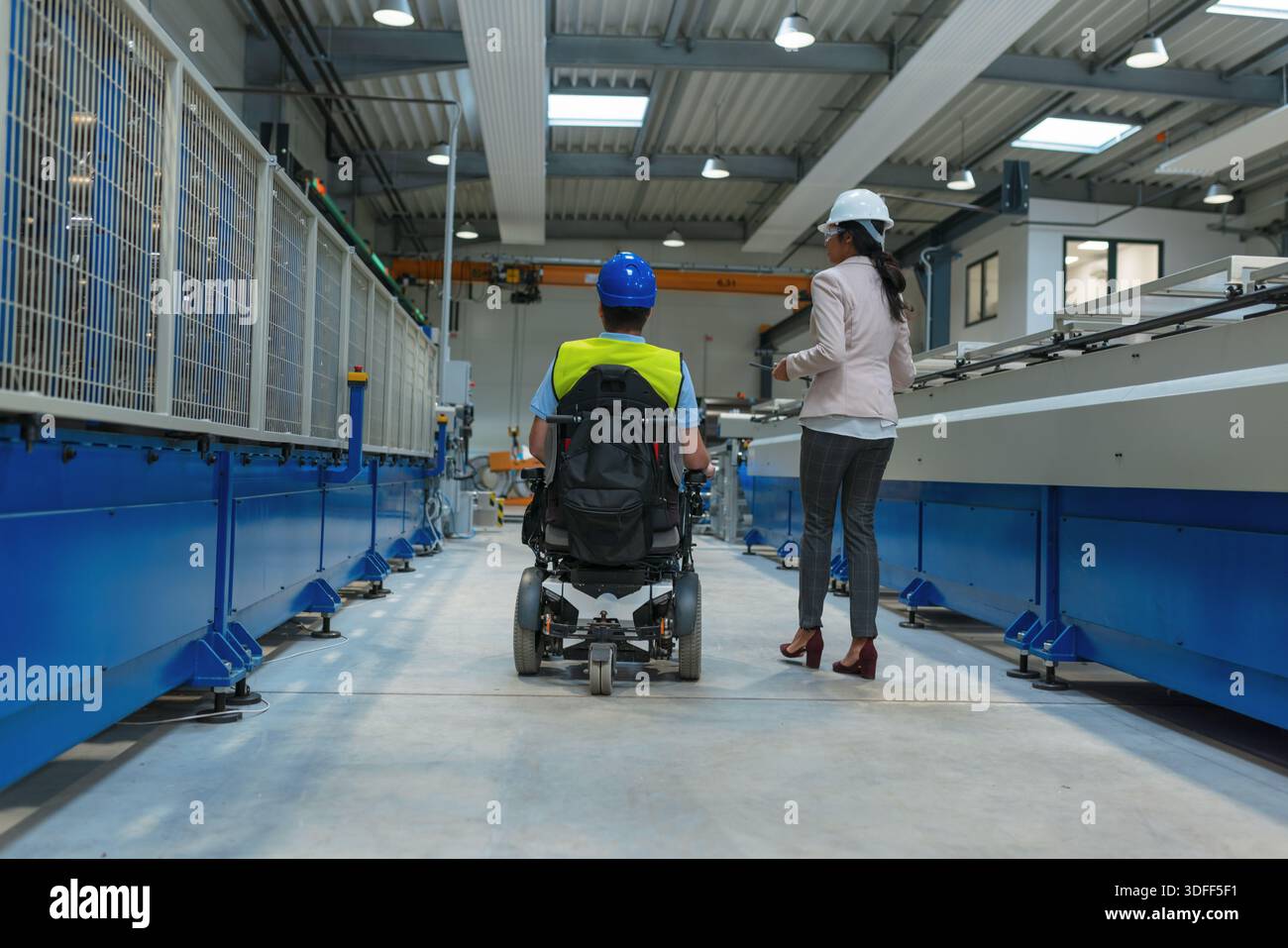 Female manager oversees production as team collaborates, highlighting ...