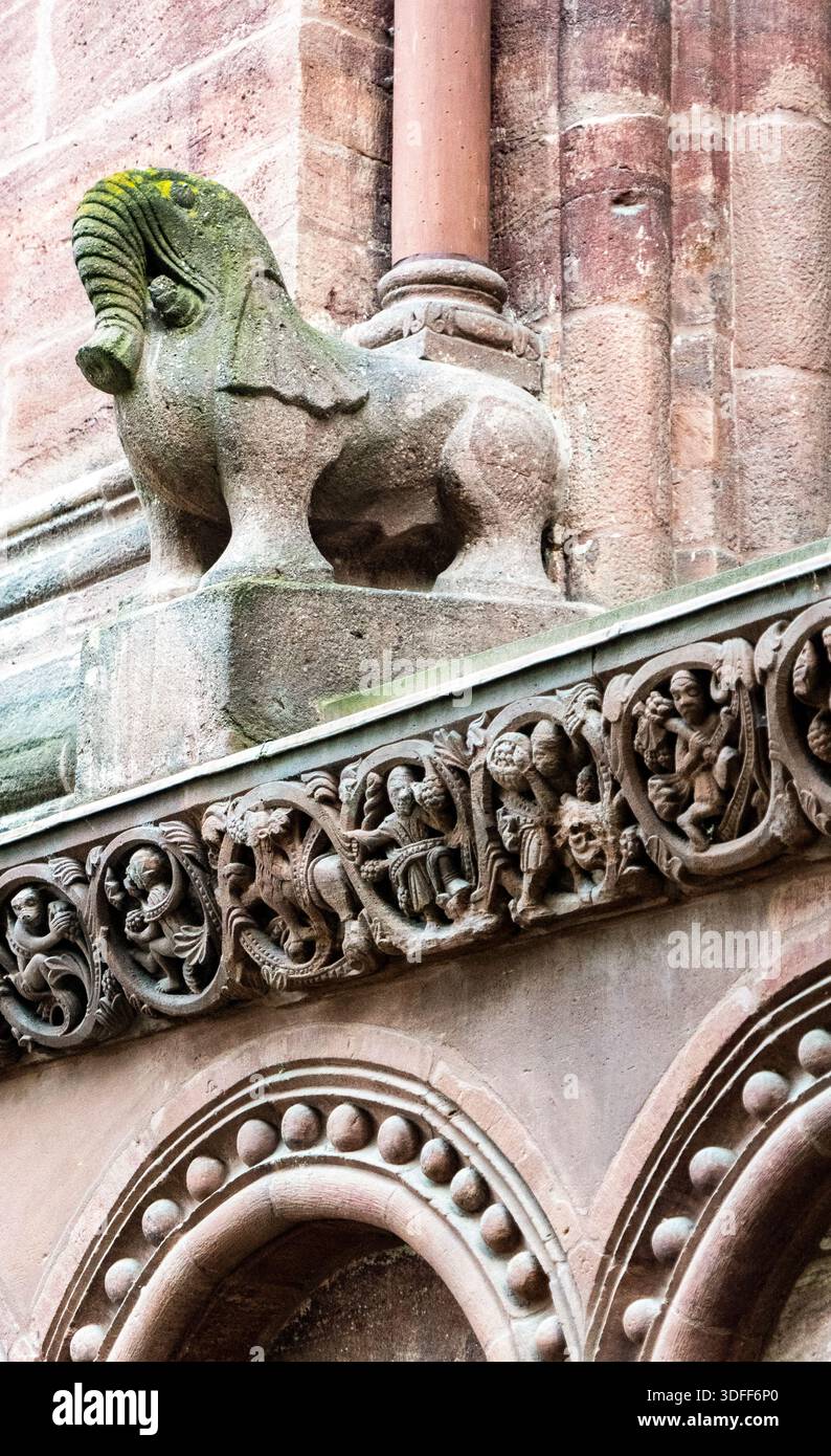 Stone sculpture of a ram and intricate carvings on a historic building ...