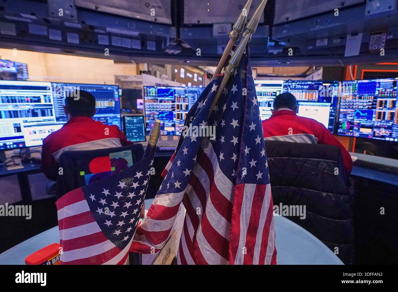 A pair of traders work on the floor of the New York Stock Exchange ...