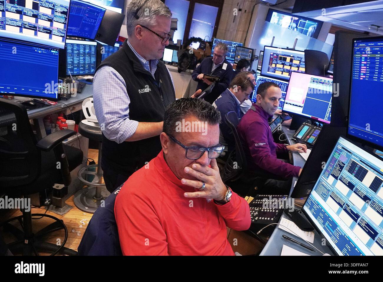 Trader Robert Finnerty Jr., foreground, works with colleagues on the ...