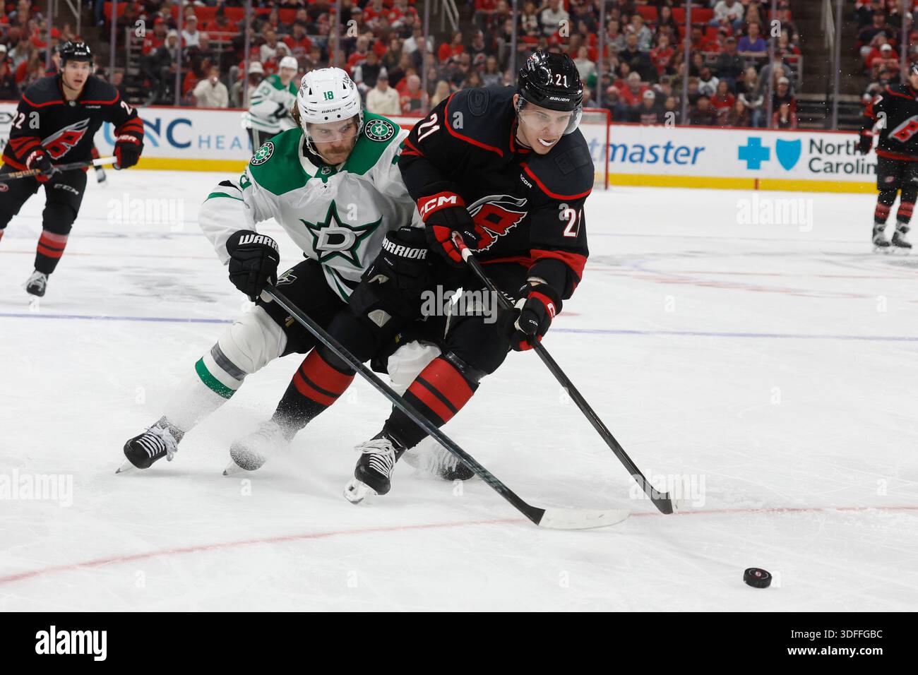 Carolina Hurricanes' Alexander Nikishin (21) protects the puck from ...