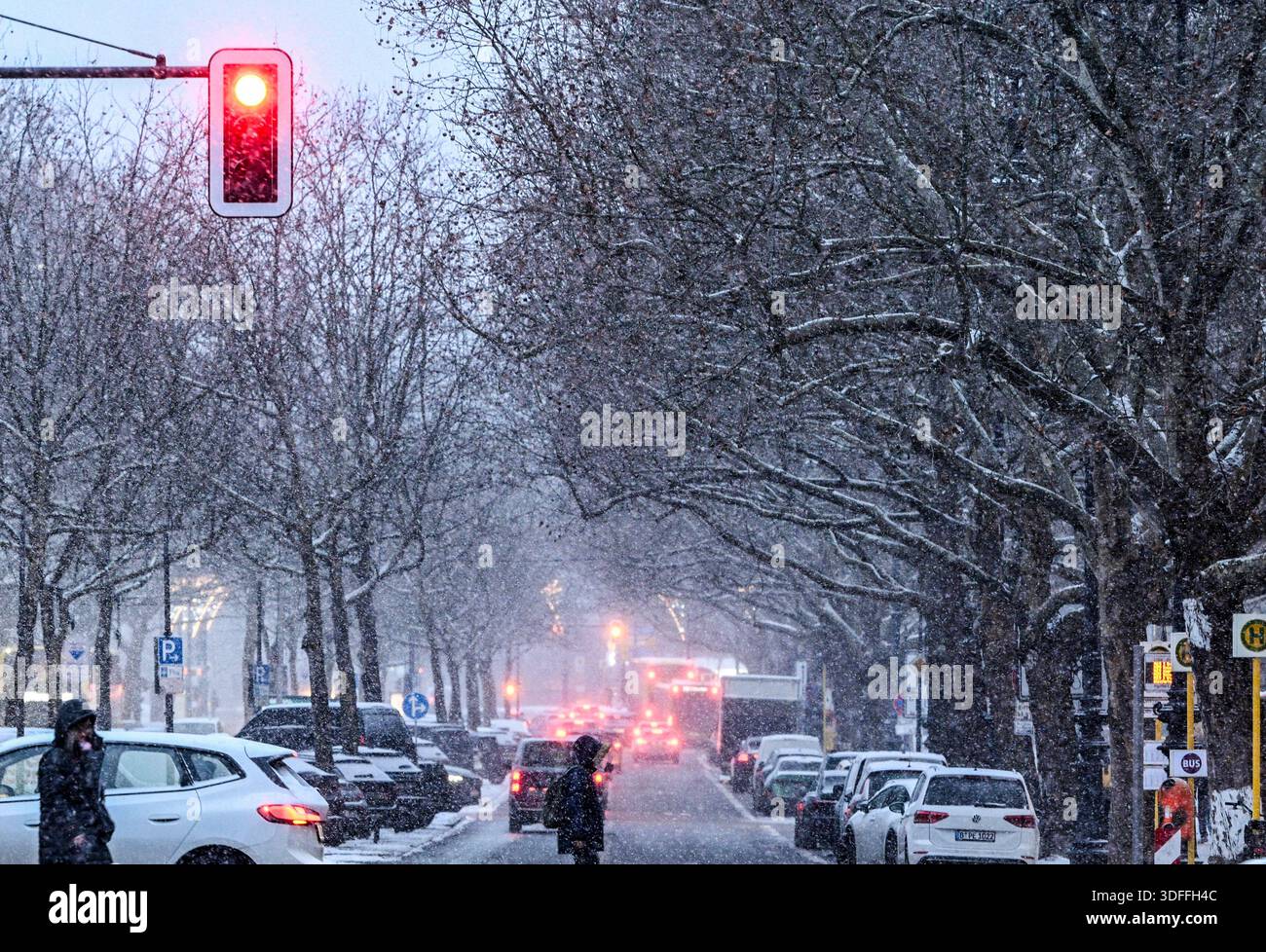12 January 2026, Berlin: Cars drive along Kurfürstendamm in the late ...