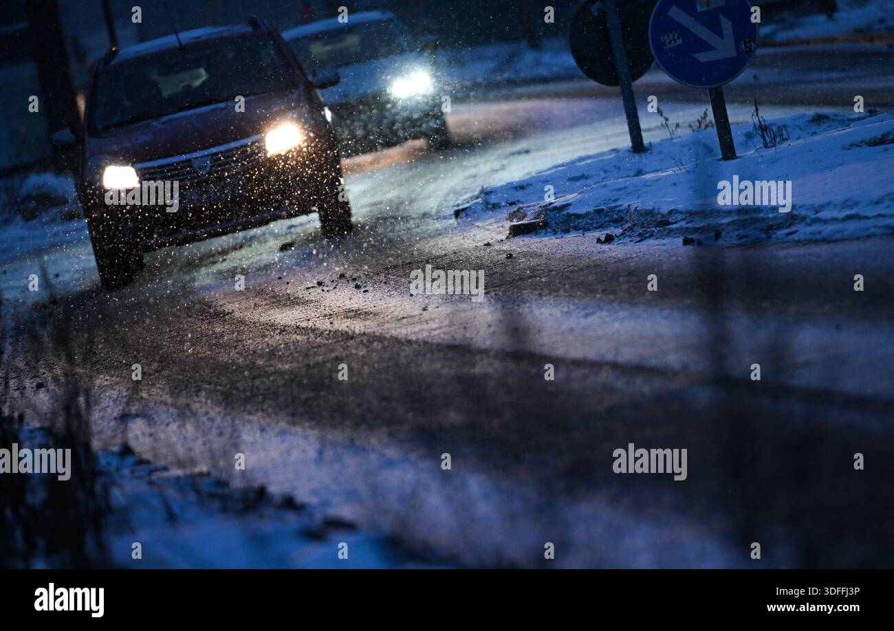 12 January 2026, Berlin: Cars drive over the slippery road in the ...