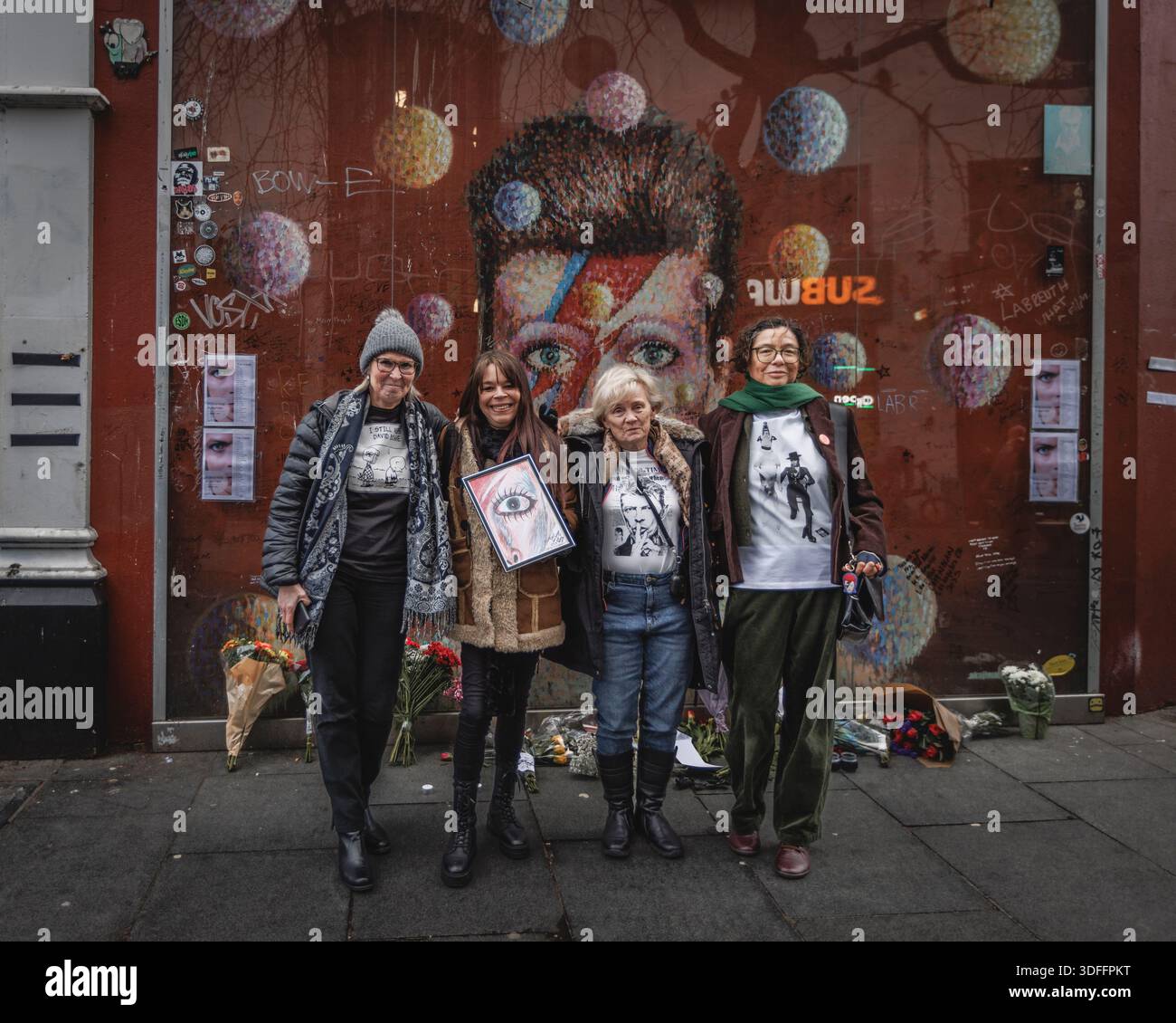 David Bowie fans pose by the mural in Brixton based on his Aladdin Sane ...