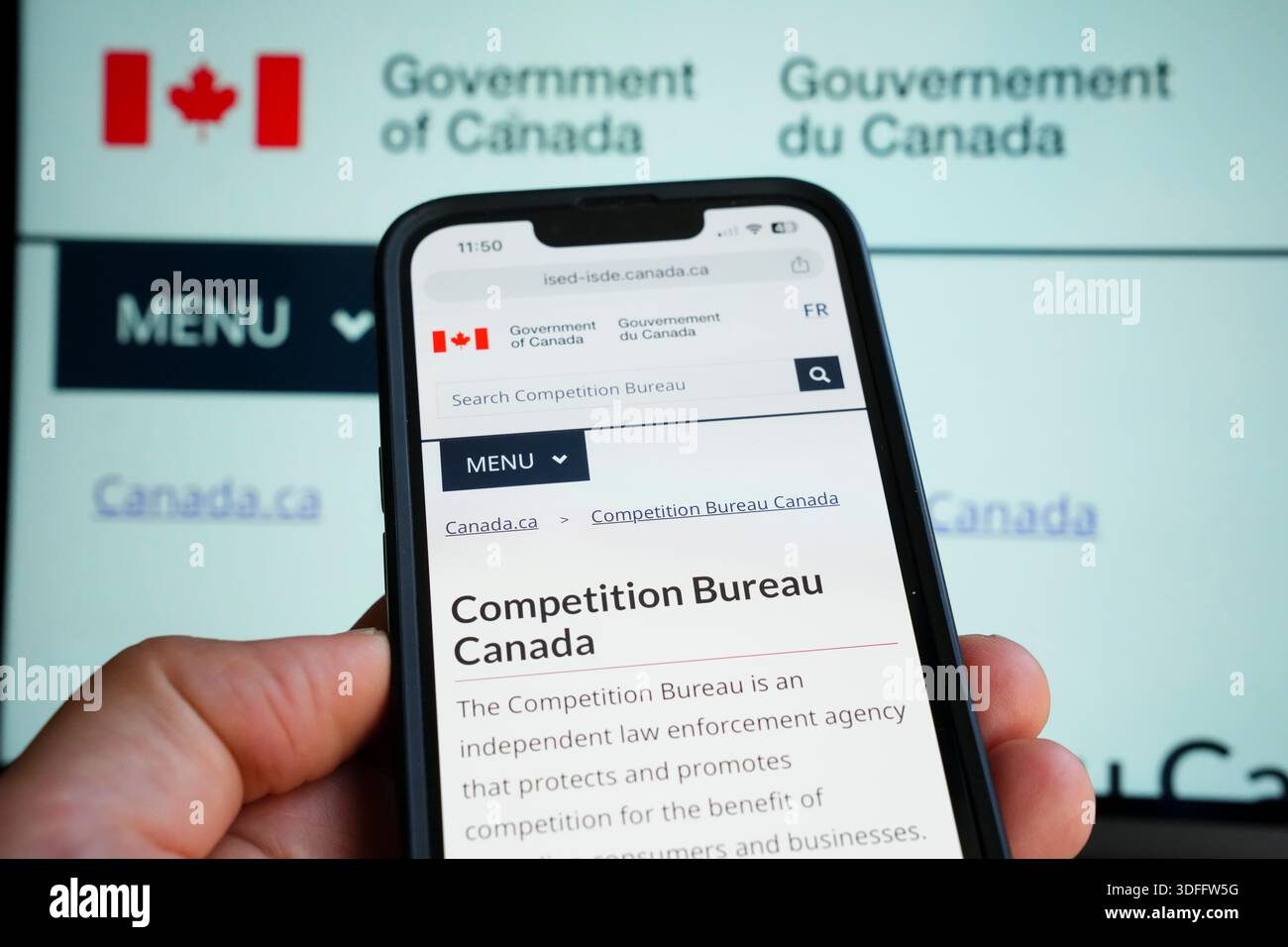 The Canadian Competition Bureau website on a mobile phone and laptop ...