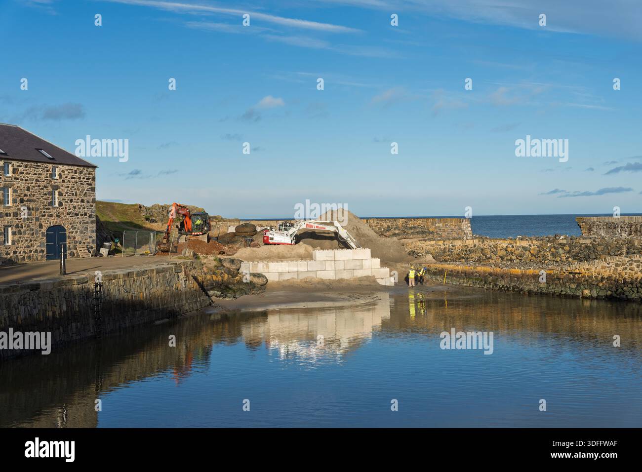Construction teams use JCB diggers to repair storm damage at Portsoy ...