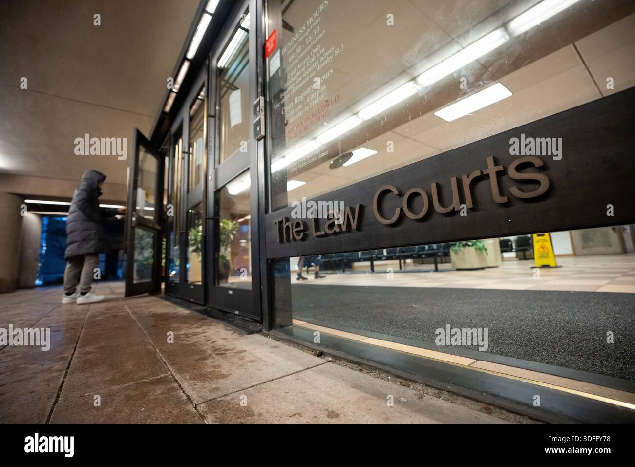 A person enters The Law Courts building, which is home to B.C. Supreme ...