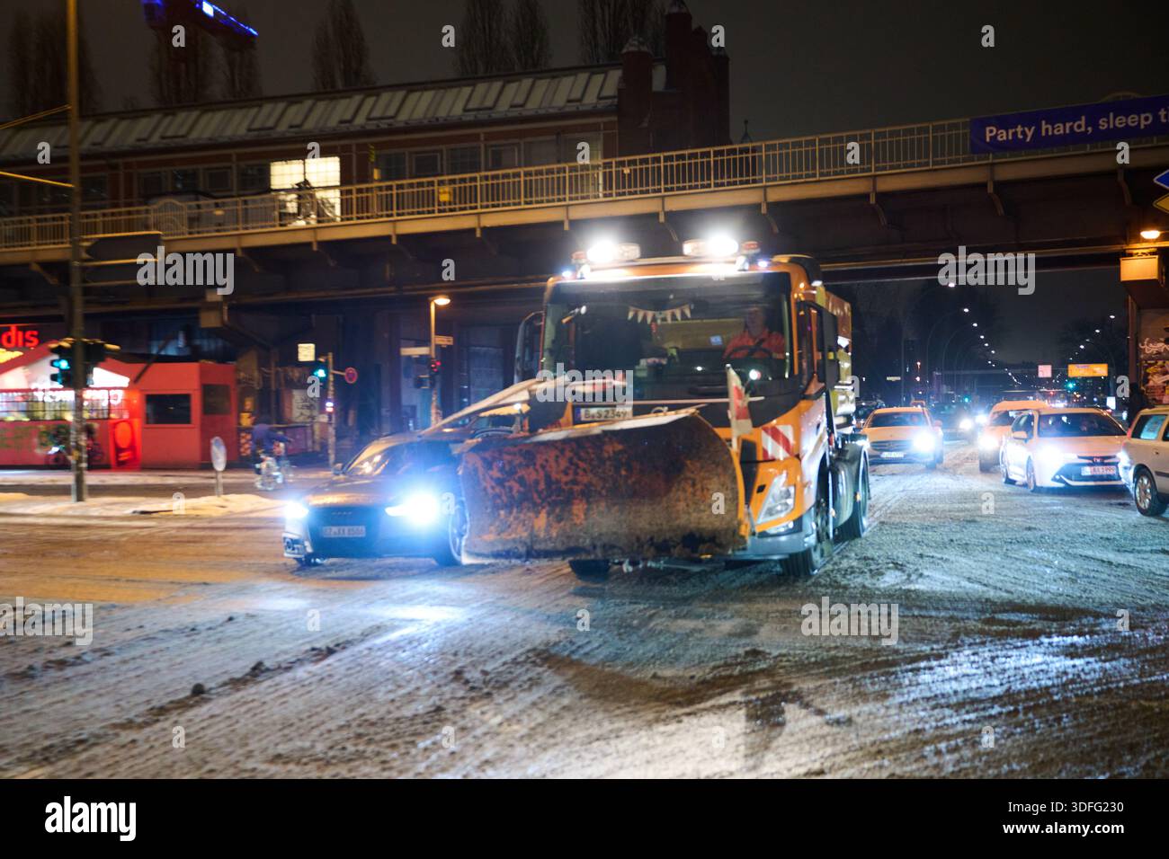 12 January 2026, Berlin: A BSR clearing and gritting vehicle drives ...