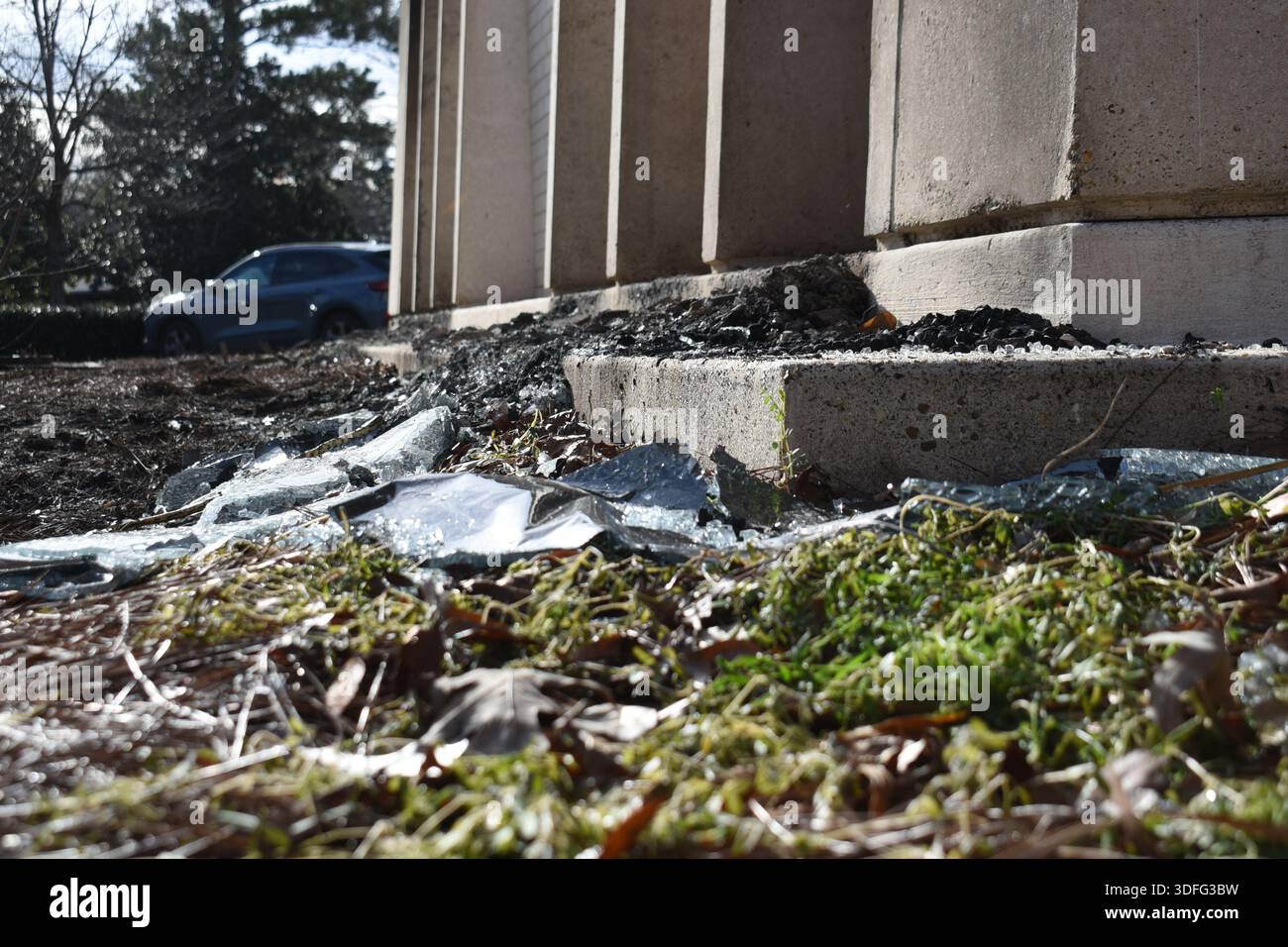 Burnt debris from a fire at the Beth Israel Congregation glint in the ...