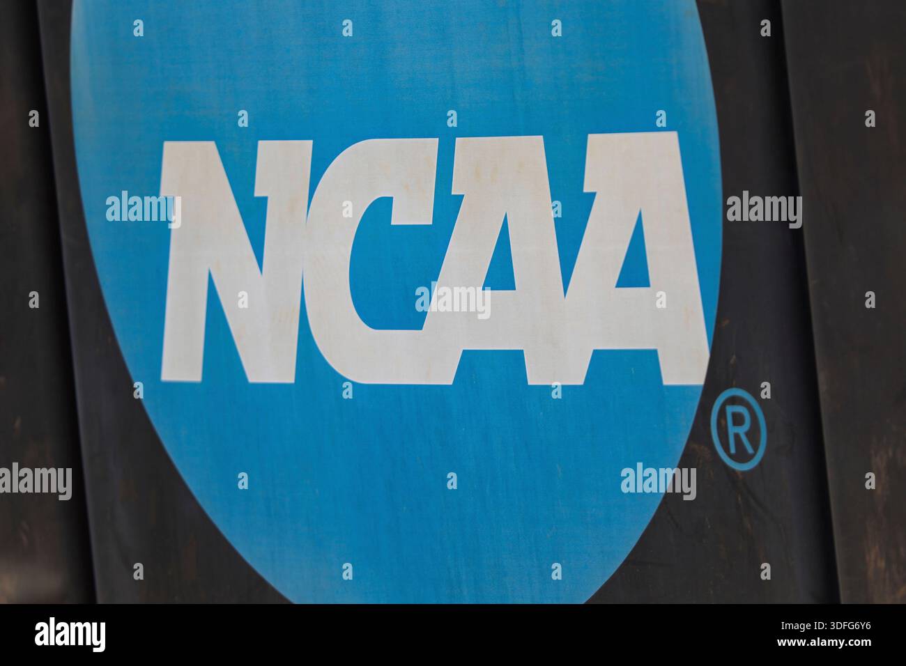 FILE - NCAA logo displayed on the fence before an NCAA softball game ...