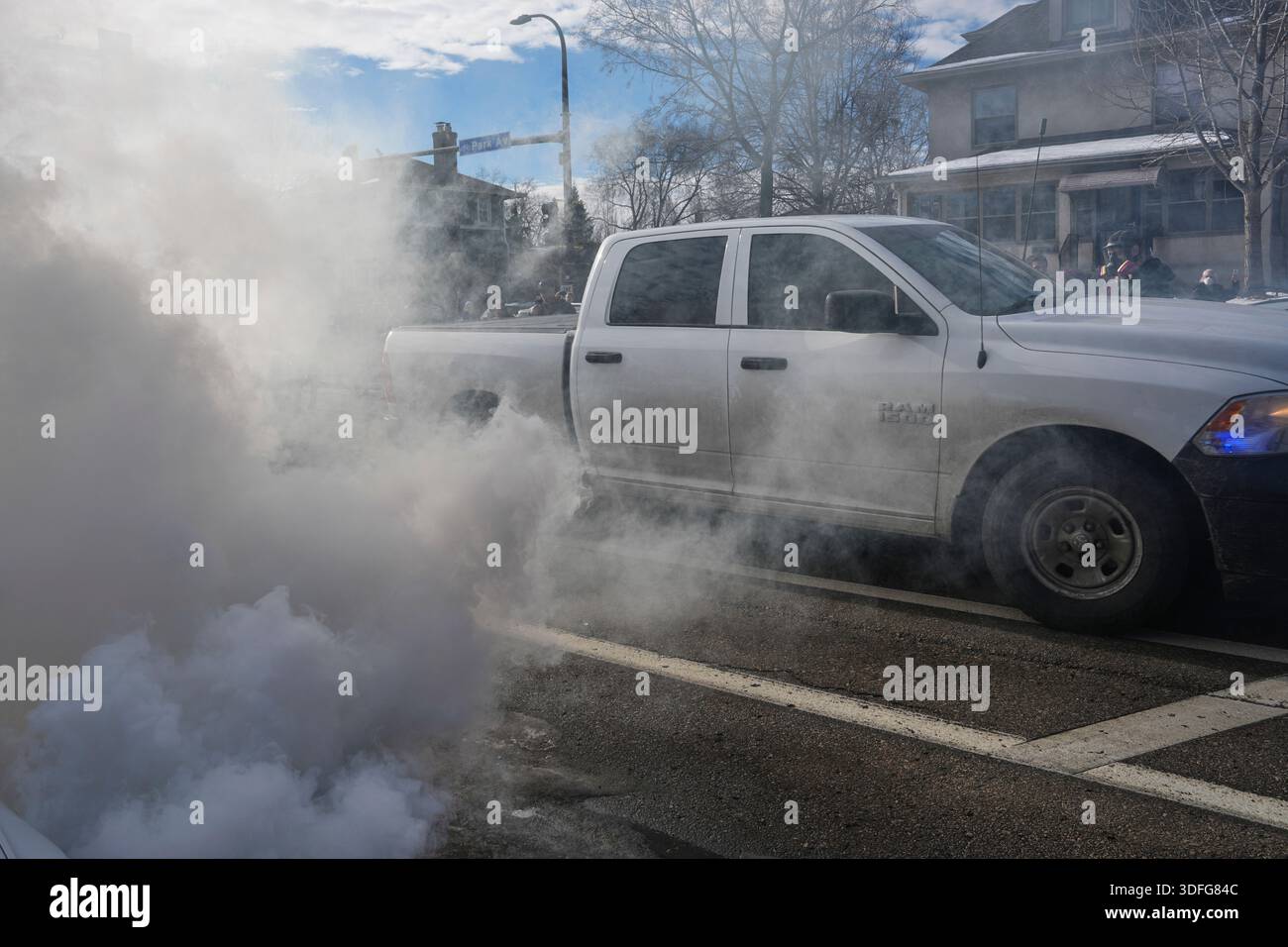 Federal agents drive through smoke from tear gas dispersed during a ...